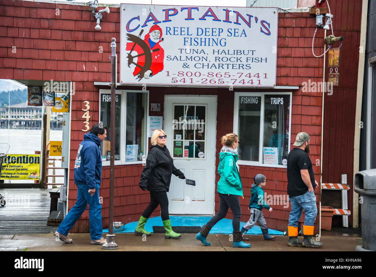 Commercial Fishing Family Walking Past Fishing Charter Store Front in ...