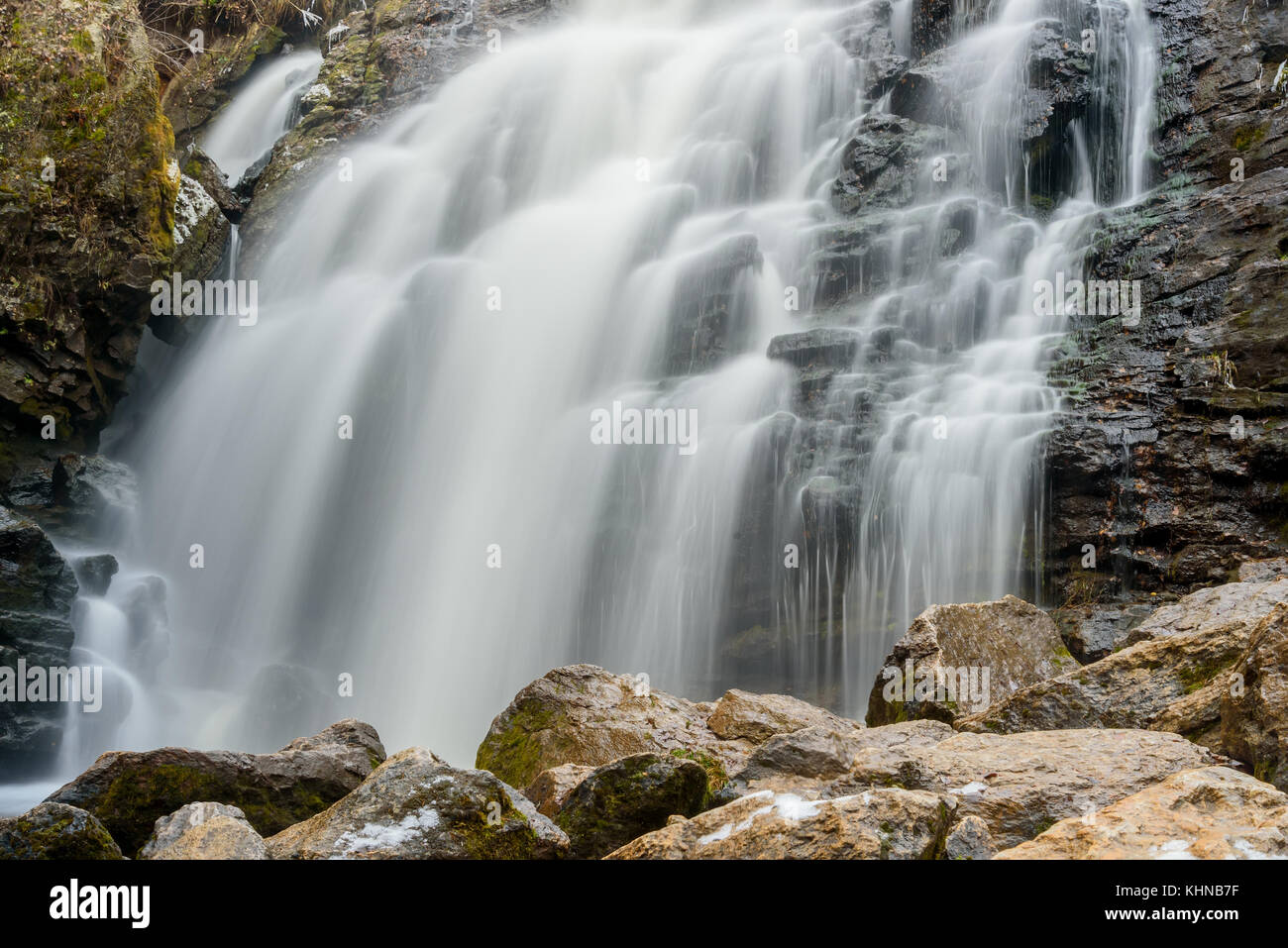 Beautiful view of the waterfall with smooth water falling among the ...