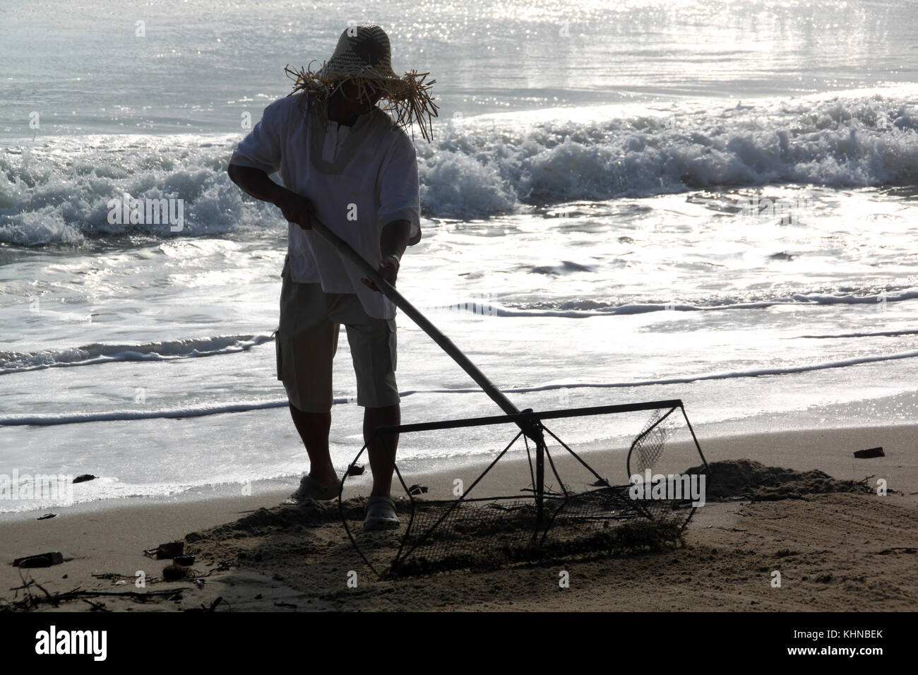 Man cleaning the sand beach in Nha Trang, Vietnam Stock Photo - Alamy