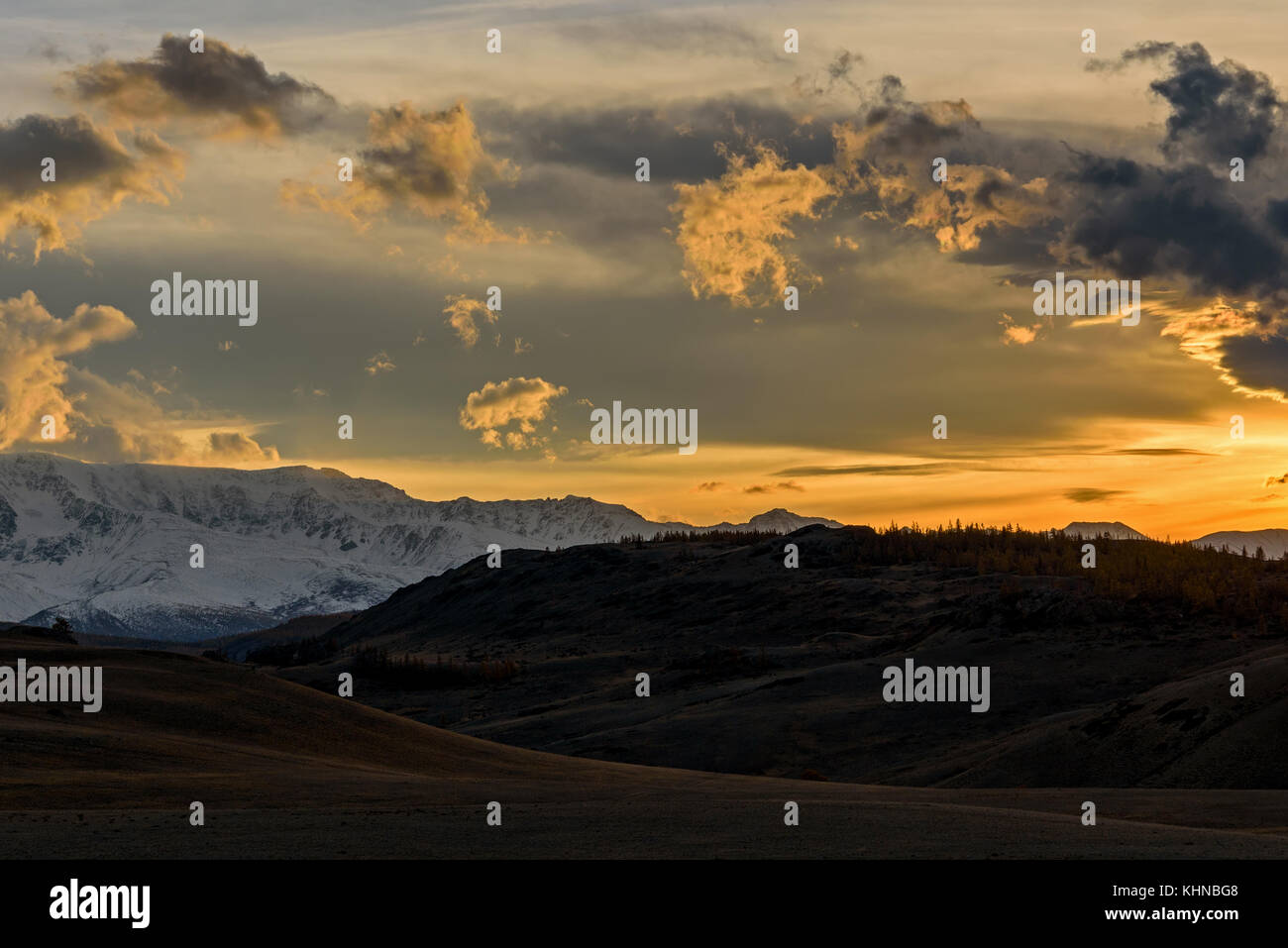 The picturesque steppe landscape with mountains covered with snow and ...