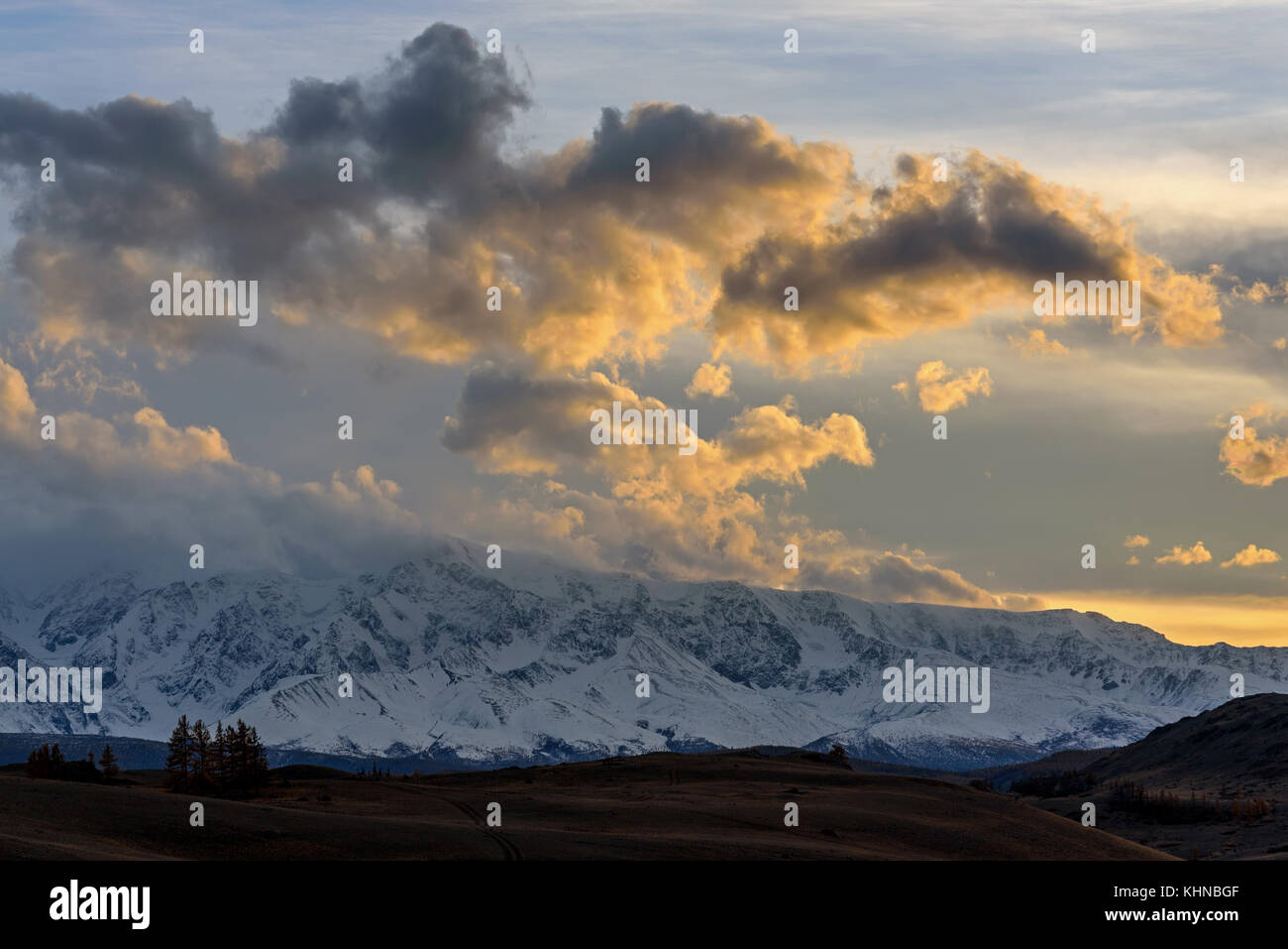 The picturesque steppe landscape with mountains covered with snow and ...