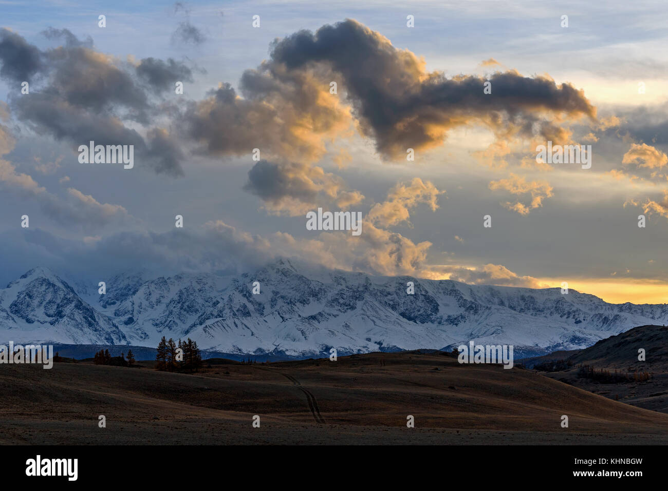 The picturesque steppe landscape with mountains covered with snow and ...