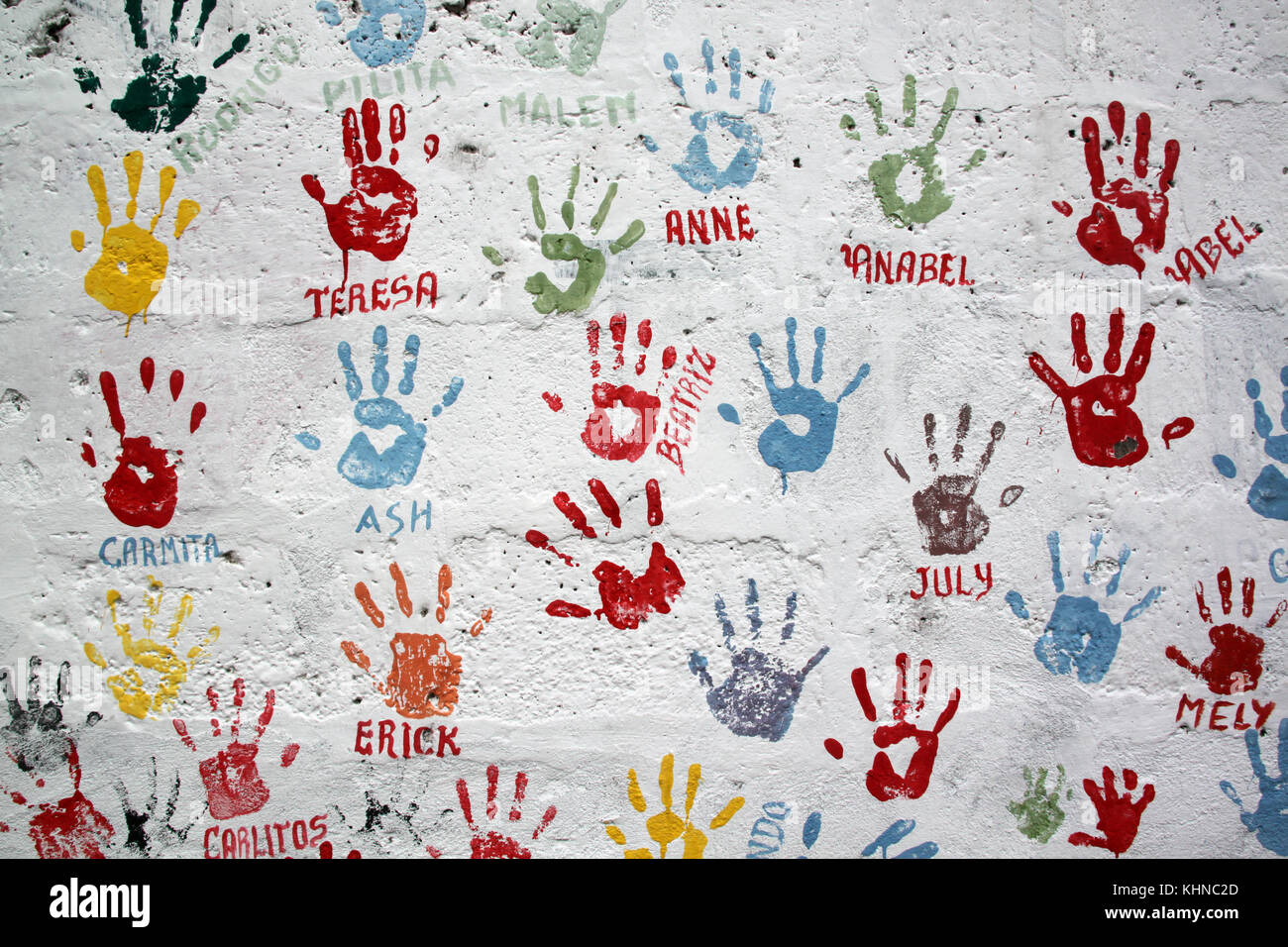 Color child palms on the white wall on the street Stock Photo - Alamy