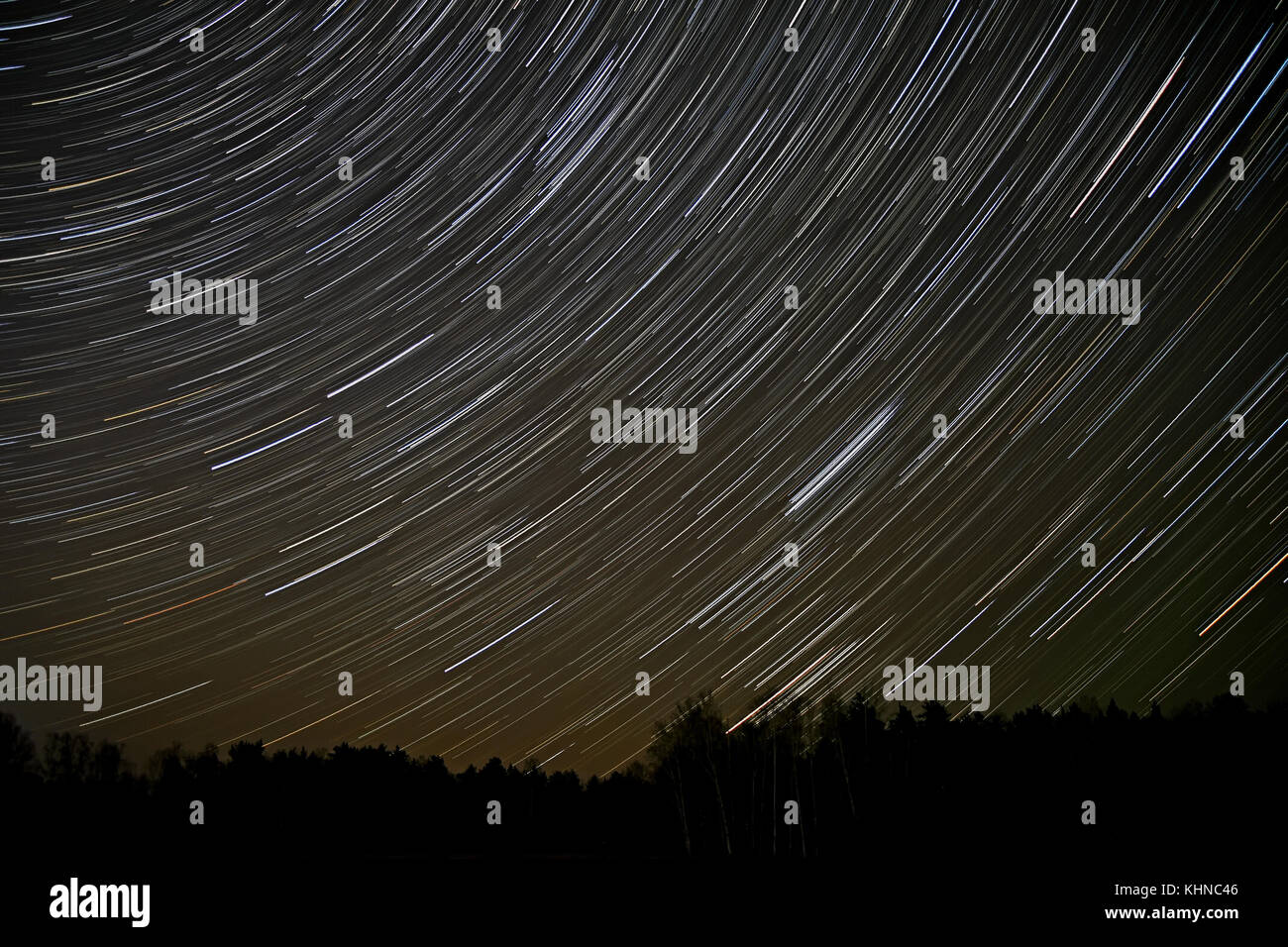 Night landscape with traces of the stars in the night sky on background ...