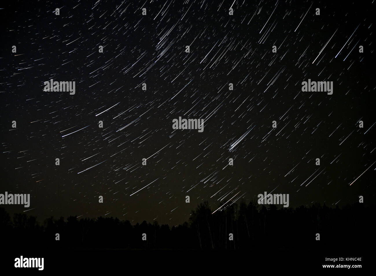 Night landscape with traces of the stars in the night sky on background ...