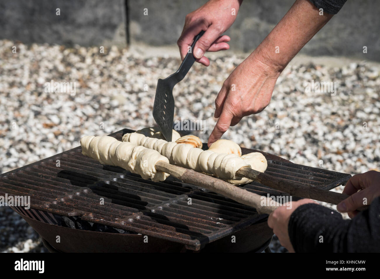 Homemade dough over a grill with hand ready to bake some bread in the ...