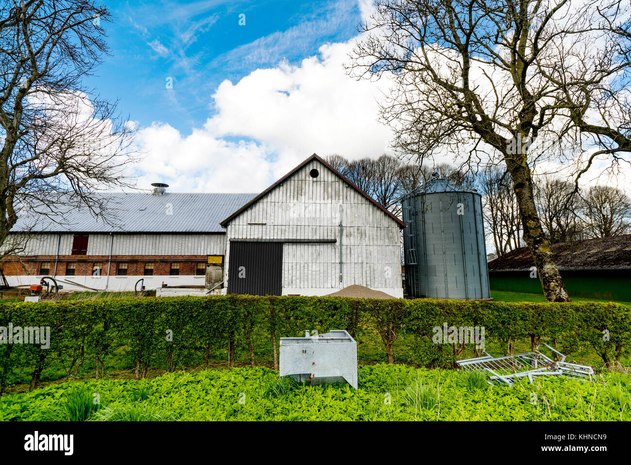 Farm with a silo and a large barn in rural environment Stock Photo - Alamy