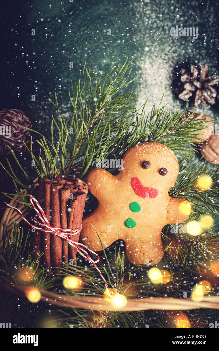 Christmas card with gingerbread man and coniferous branches in basket ...
