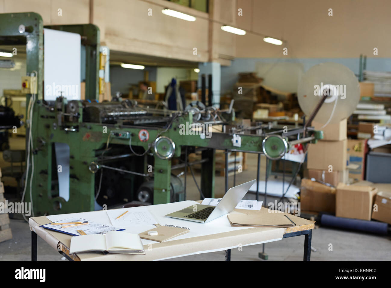Workplace of technical worker with laptop and notepads on background of ...