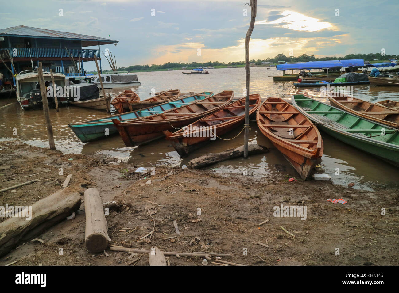 Wooden canoe in river port at Amazonas rain forest Stock Photo - Alamy
