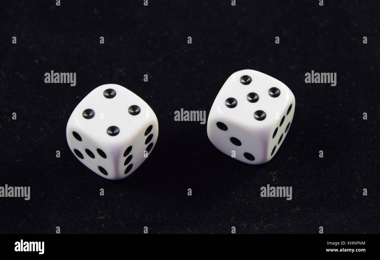 A pair white of dice showing Five and four Stock Photo - Alamy