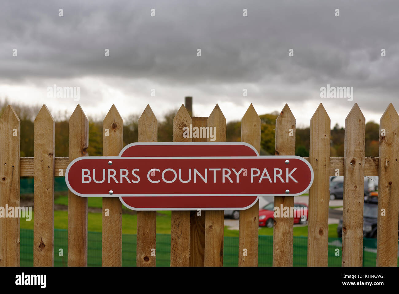 Railway totem railway sign mounted on wooden fencing under an overcast ...