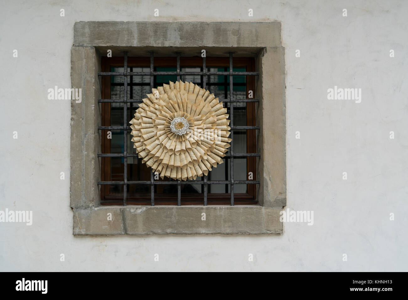 a paper wheel decorates a window of a house in the historic center of ...
