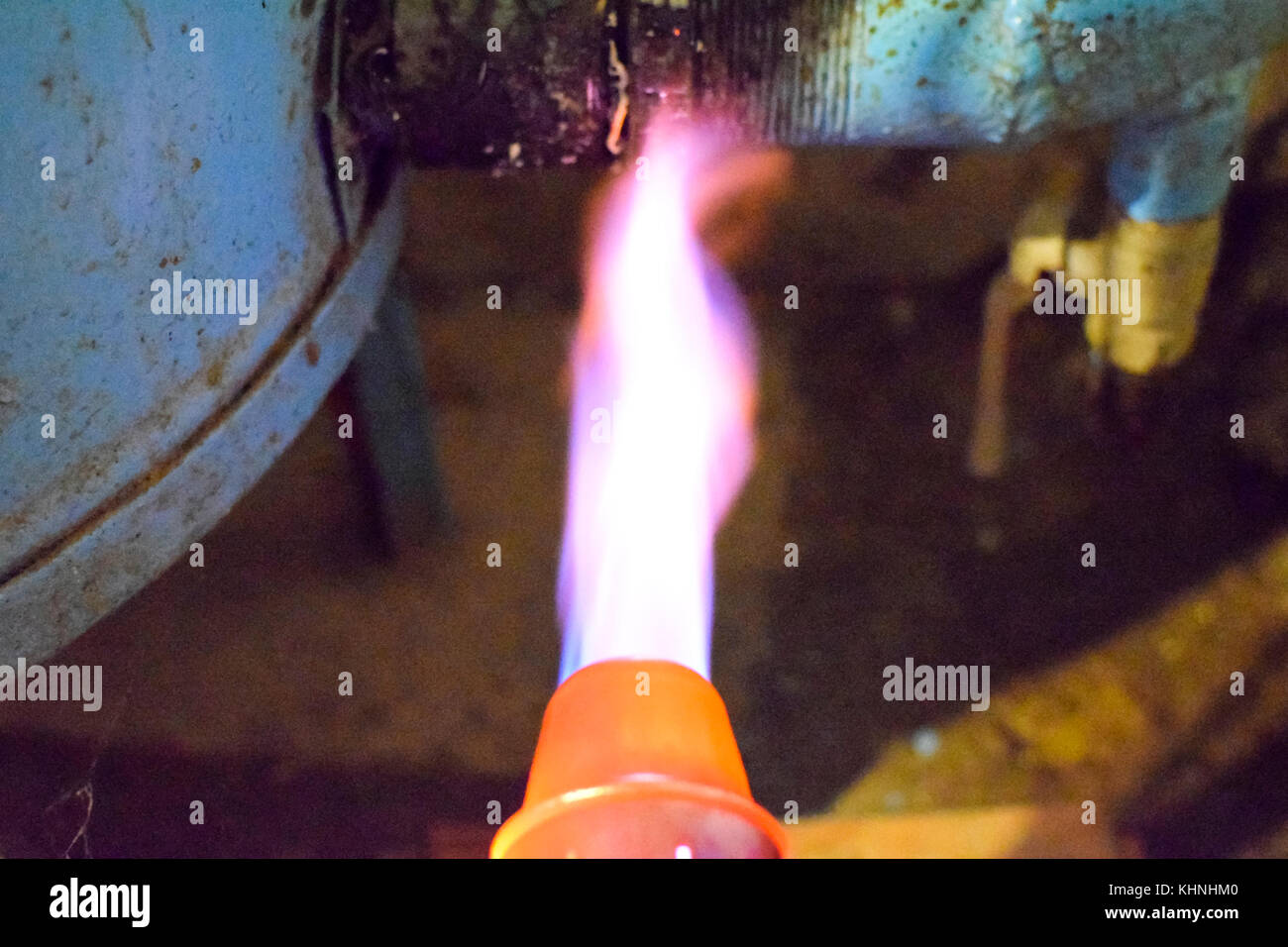 Heating a steel pipe with a blowtorch. The flame of a blowtorch Stock ...