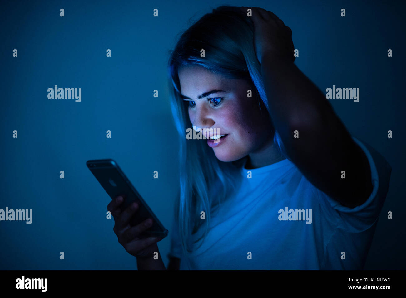 Problems on-line: a teenage girl looking at her Facebook Instagram ...