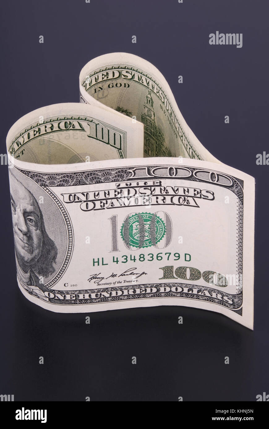 Heart shaped money, on black background Stock Photo - Alamy