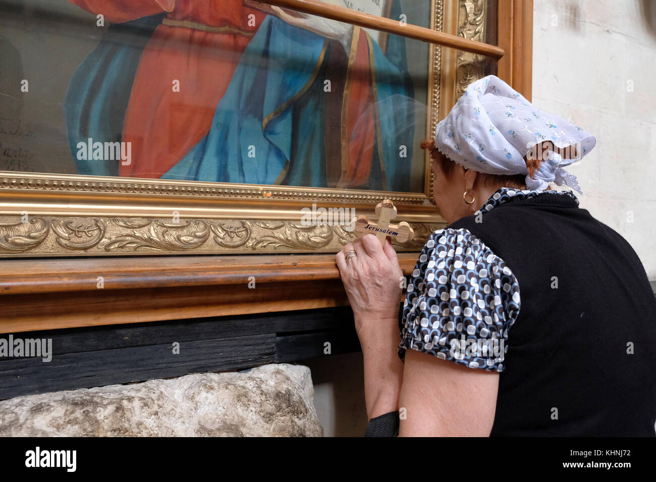 A Russian Orthodox pilgrim praying inside the Church of Saint Alexander ...