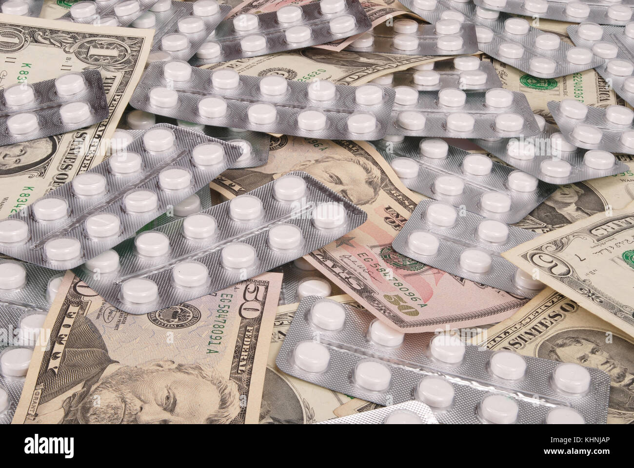 Dollars and tablets. Concept expensive medicines Stock Photo - Alamy