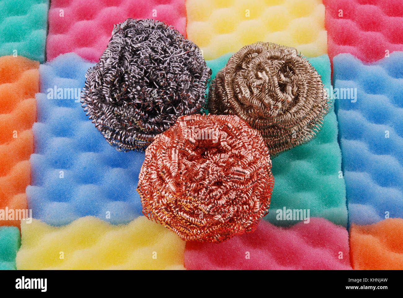 Metal sponge on a background color sponges Stock Photo - Alamy