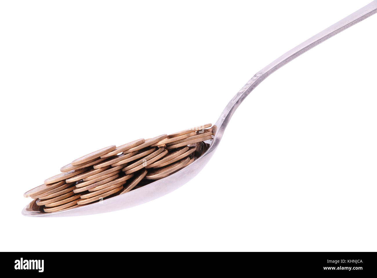 Conceptual image with the spoon full of coins. On white background ...