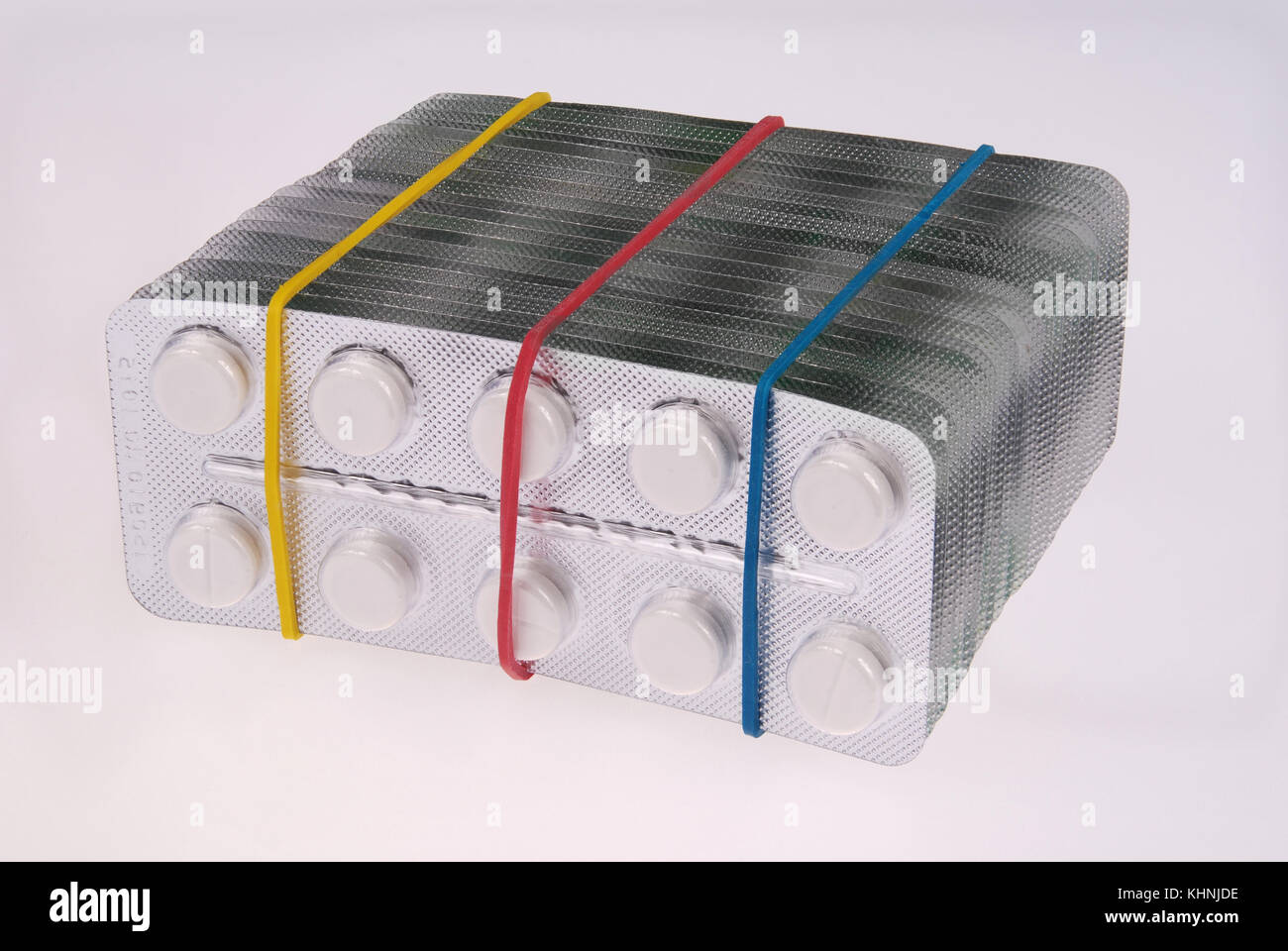 Plenty of white tablets in packing. Silver packs pills. On grey ...