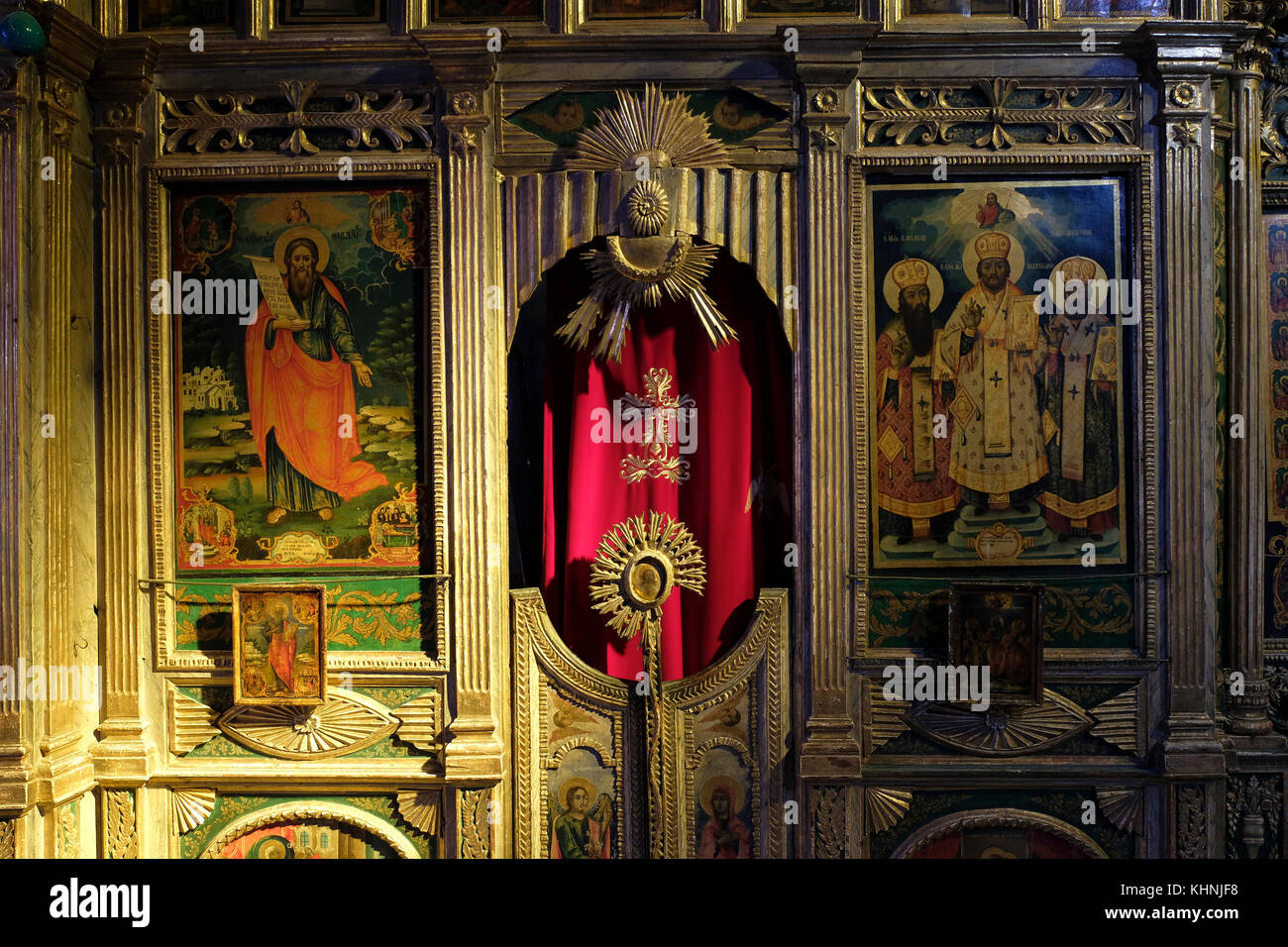 The wooden iconostasis with icons and religious paintings inside the Greek Orthodox Church and ...