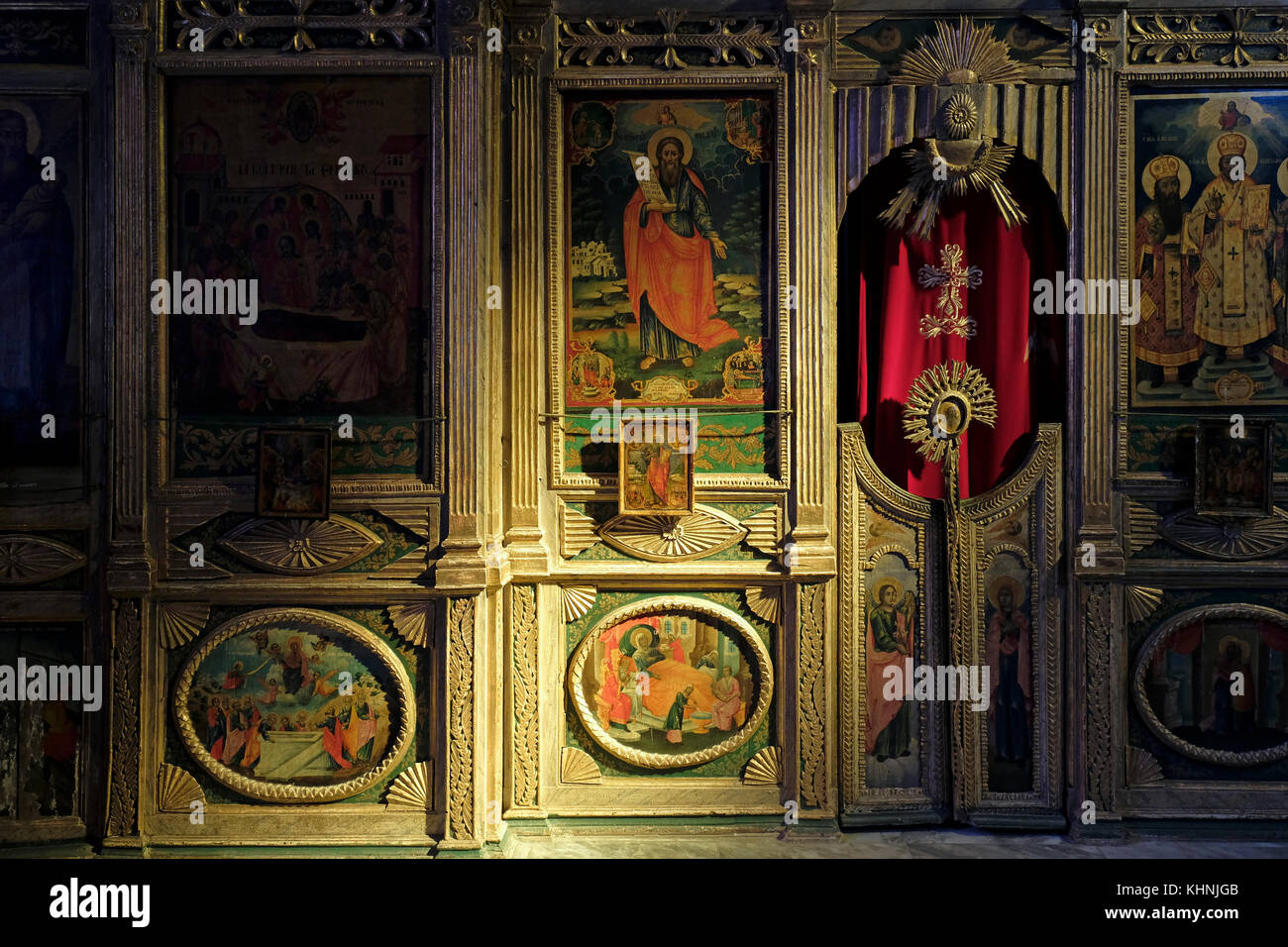 The wooden iconostasis with icons and religious paintings inside the Greek Orthodox Church and ...
