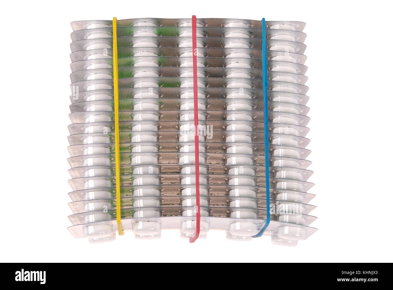 Plenty of white tablets in packing. Silver packs pills. On grey ...