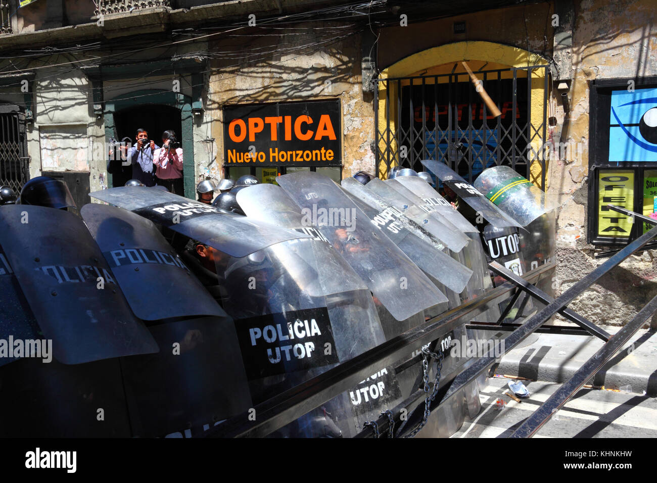Press photographers behind a riot police road block take photos of ...