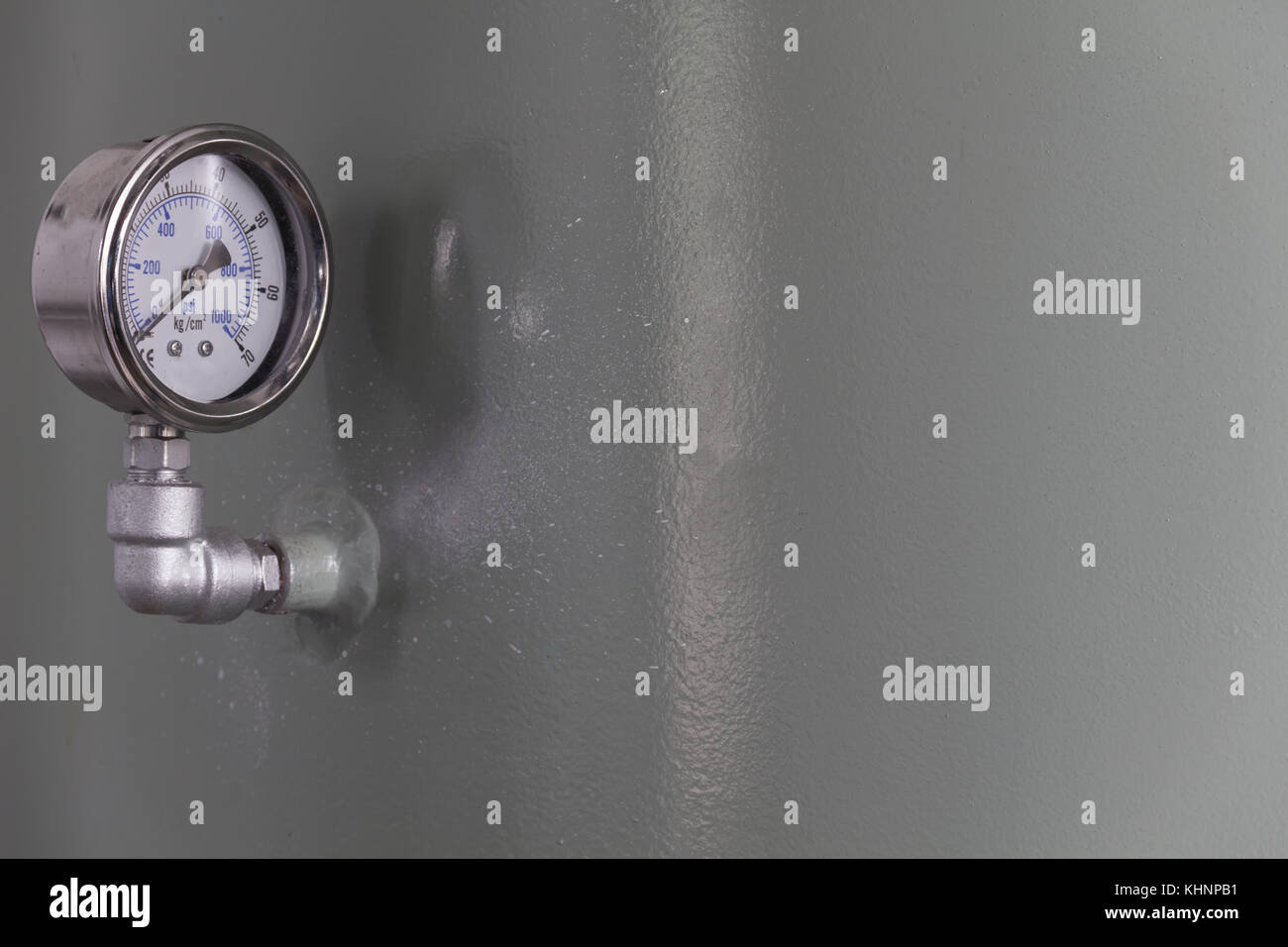 Closeup of a high pressure manometer, measuring natural gas pressure. Pipes and valves in the ...