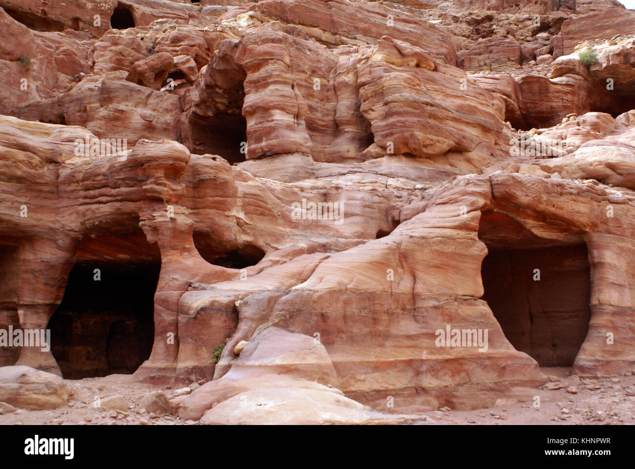 Caves in the red cliff in Petra, Jordan Stock Photo - Alamy