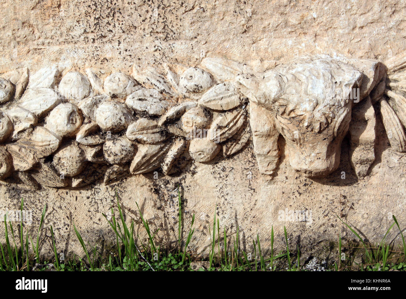 Grass and bas-relief on the street in Apamea, Syria Stock Photo - Alamy