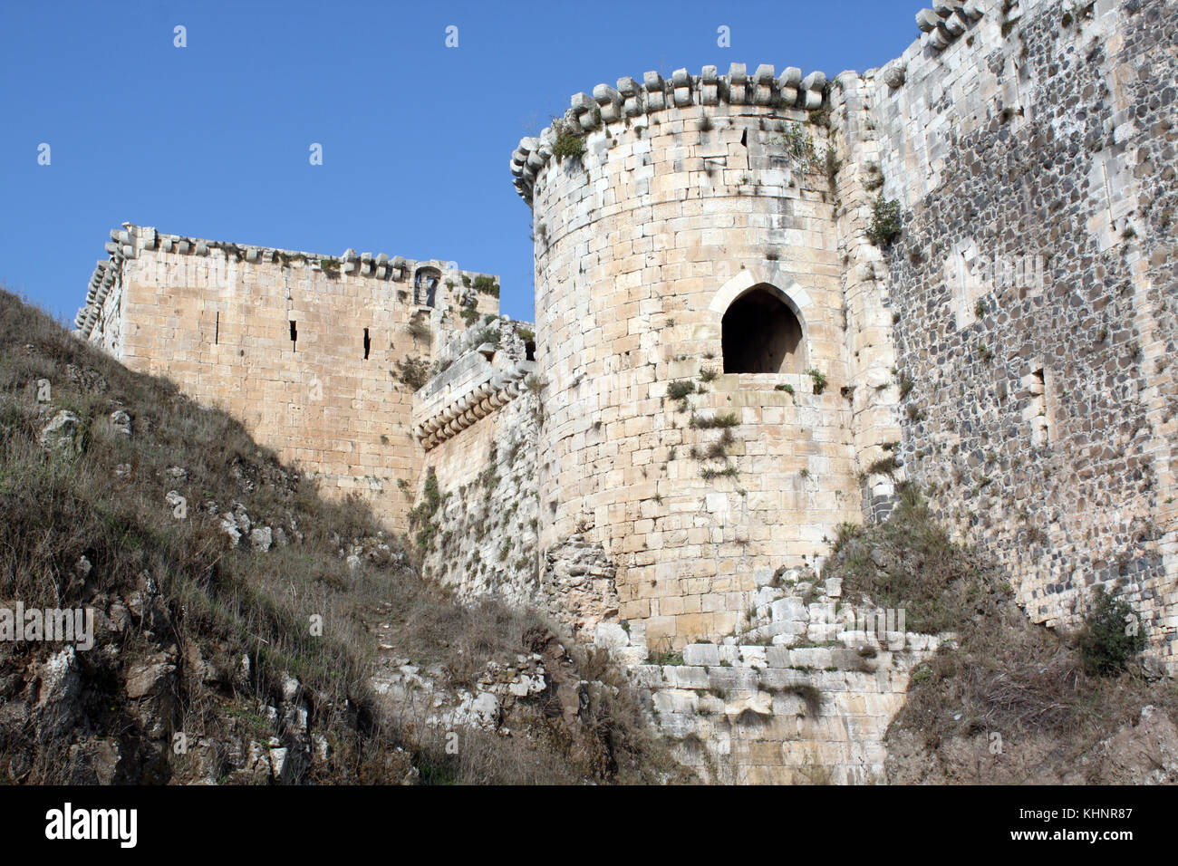 Wall and tower of castle Krak de Chevalier in Syria Stock Photo - Alamy