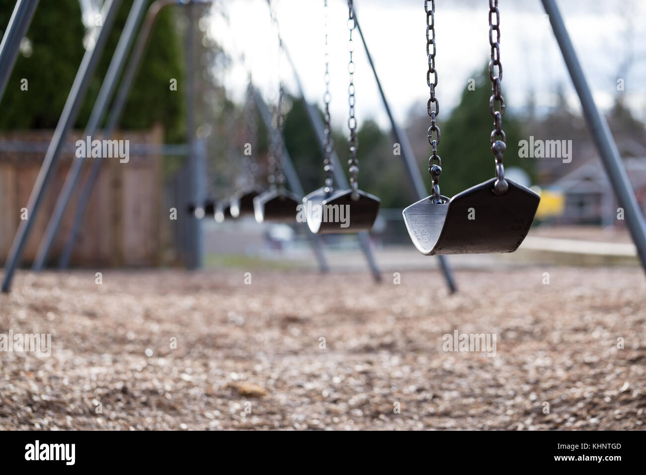 Swings in a playground Stock Photo - Alamy