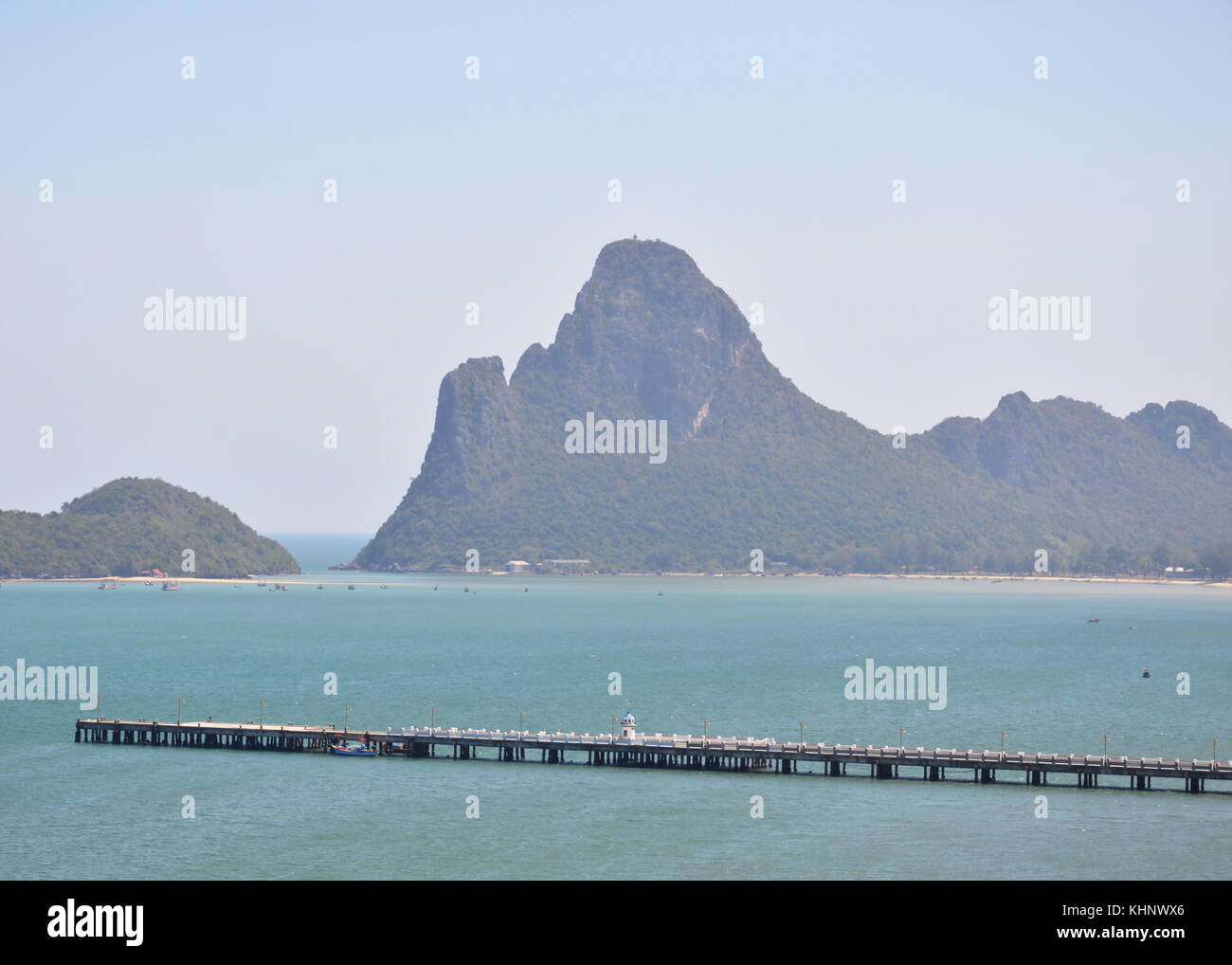 landscape of jetty long to sea and mountain background Stock Photo - Alamy