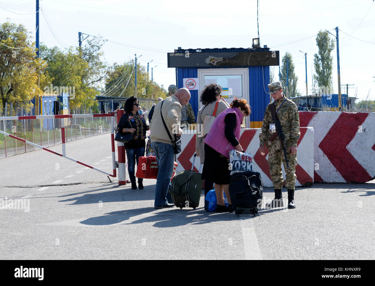 Border guard checking bags of travelers at the border crossing point ...