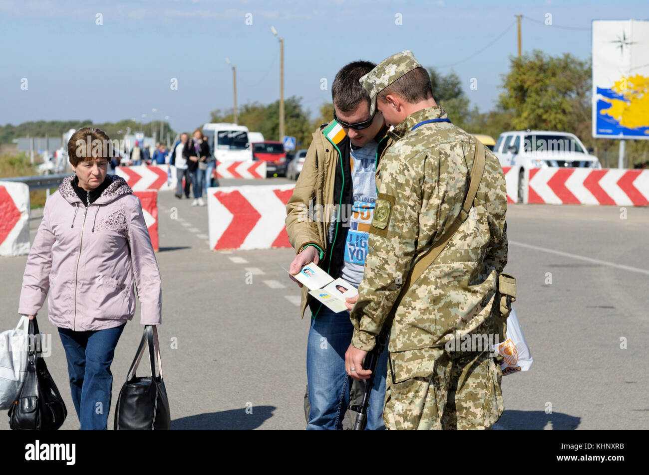 Border guard checking traveler’s passport at the border crossing point ...