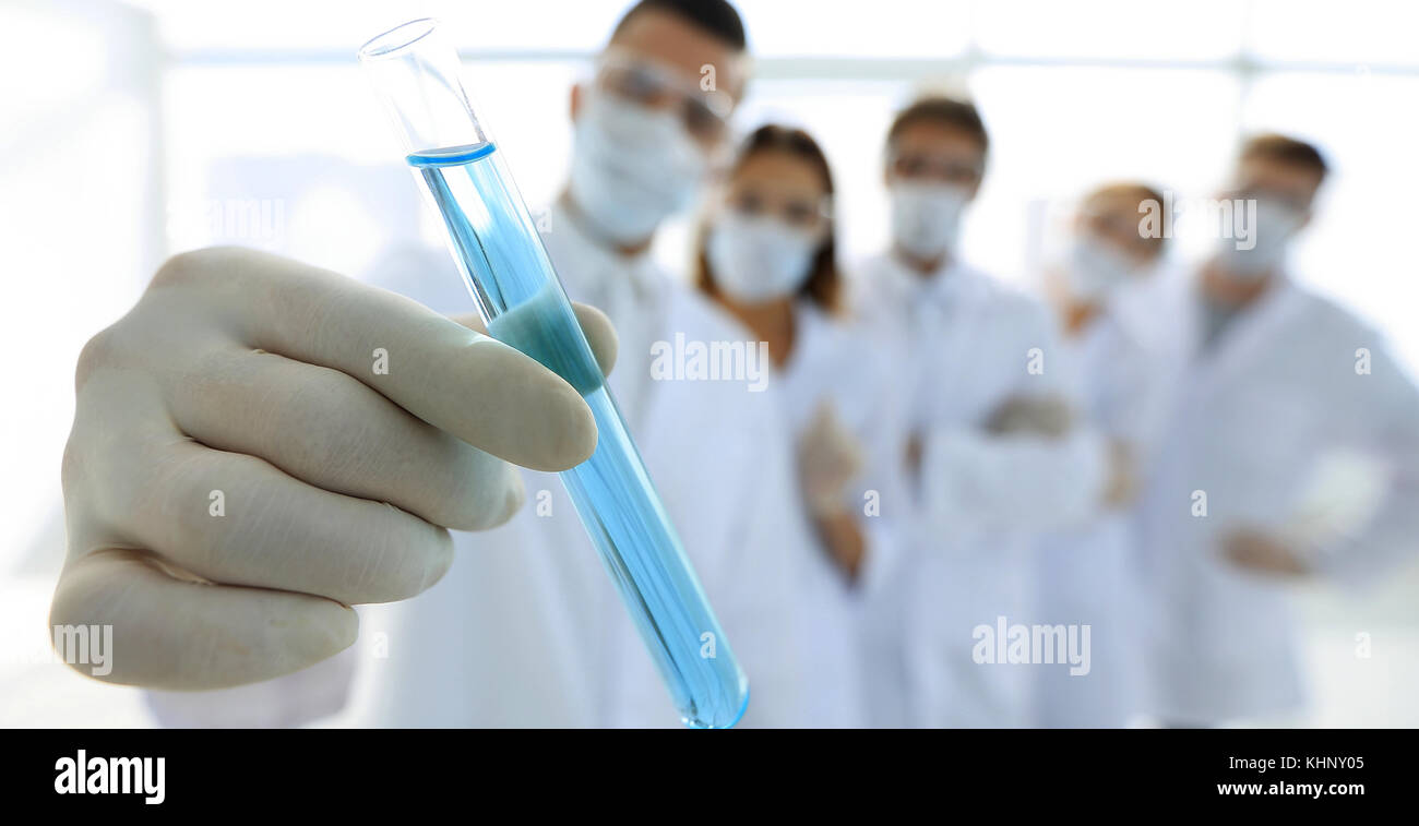 background image is a group of medical workers working with liquids in ...