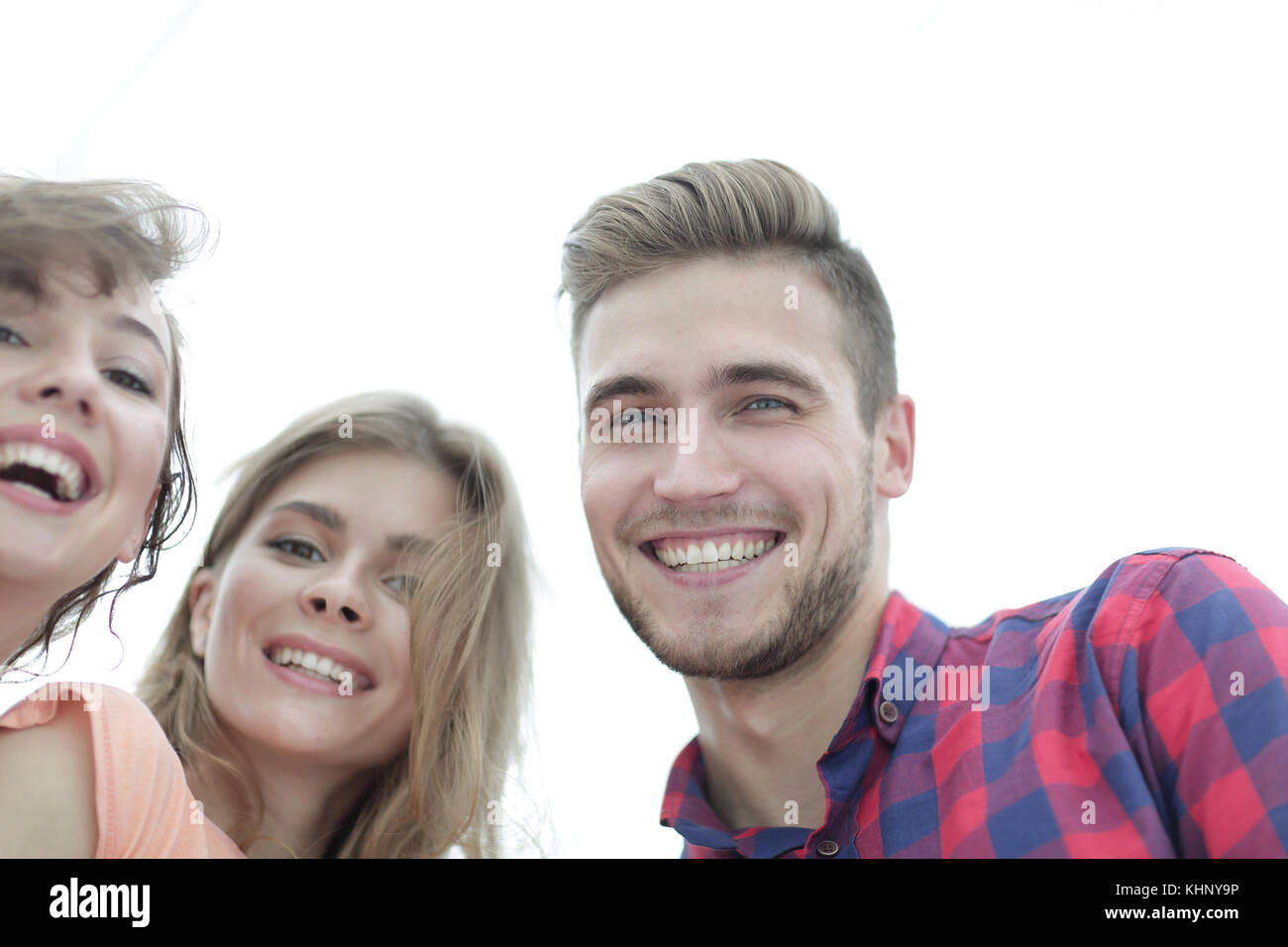 closeup of three young people smiling on white background Stock Photo ...