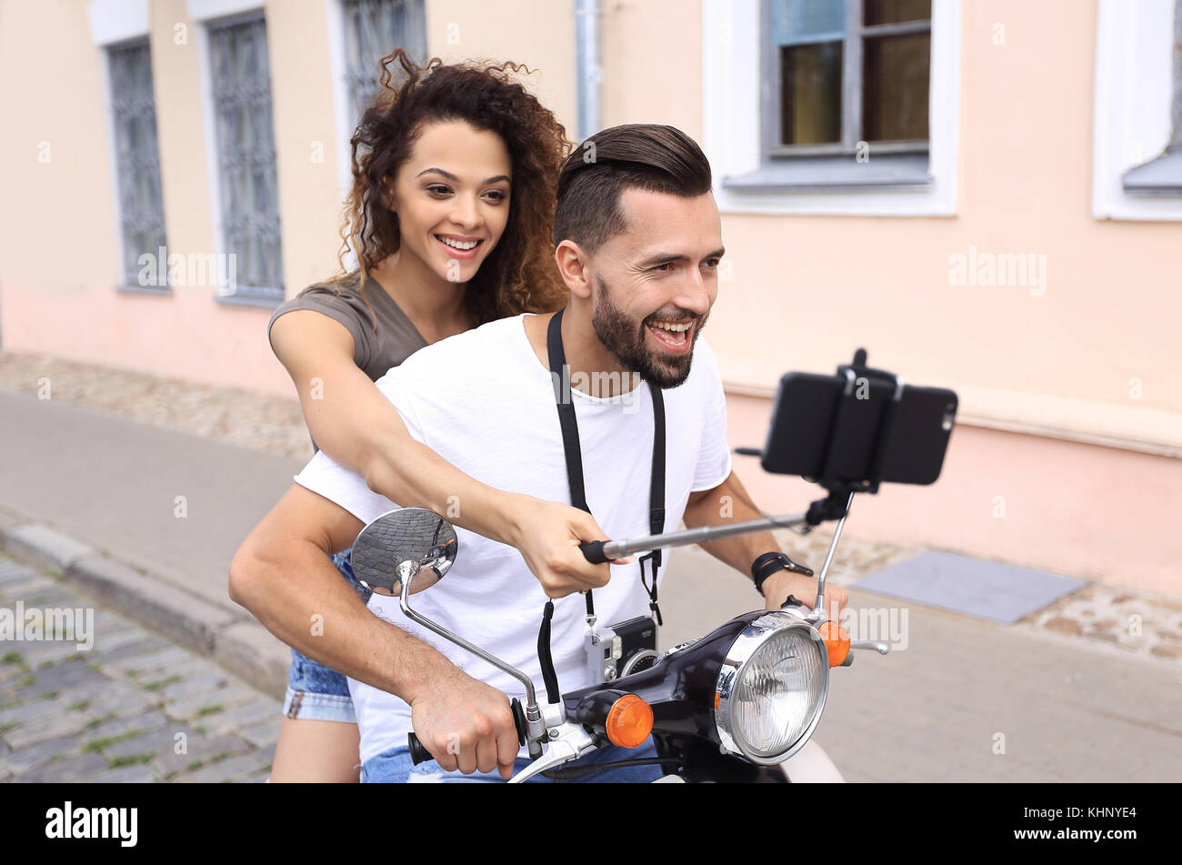Happy couple on scooter making selfie on smartphone outdoor Stock Photo ...