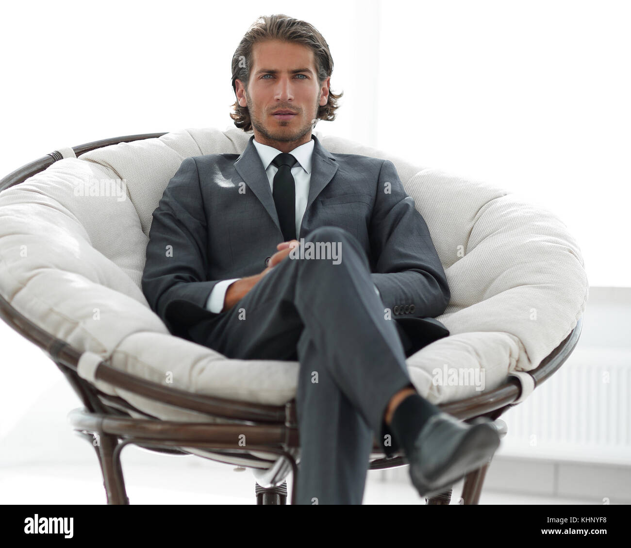 confident businessman sitting in a large comfortable chair Stock Photo ...