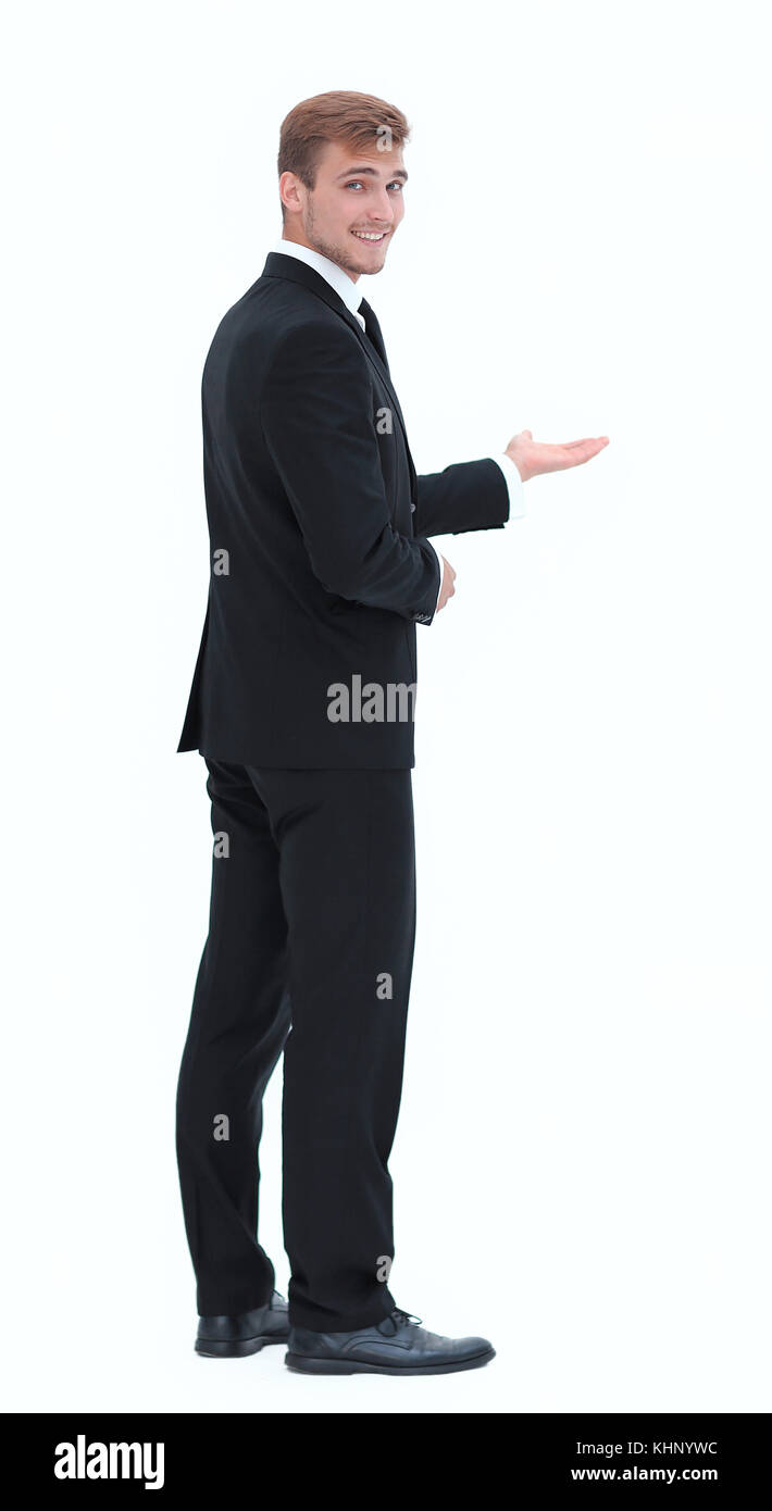 rear view.smiling businessman pointing forward. photo in full growth ...