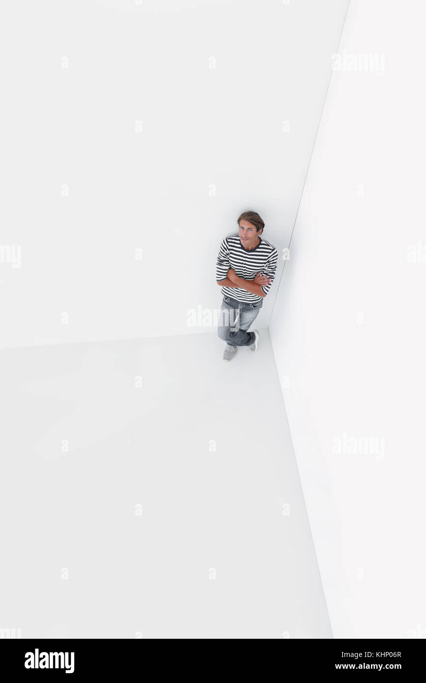 handsome guy standing near the white wall Stock Photo - Alamy