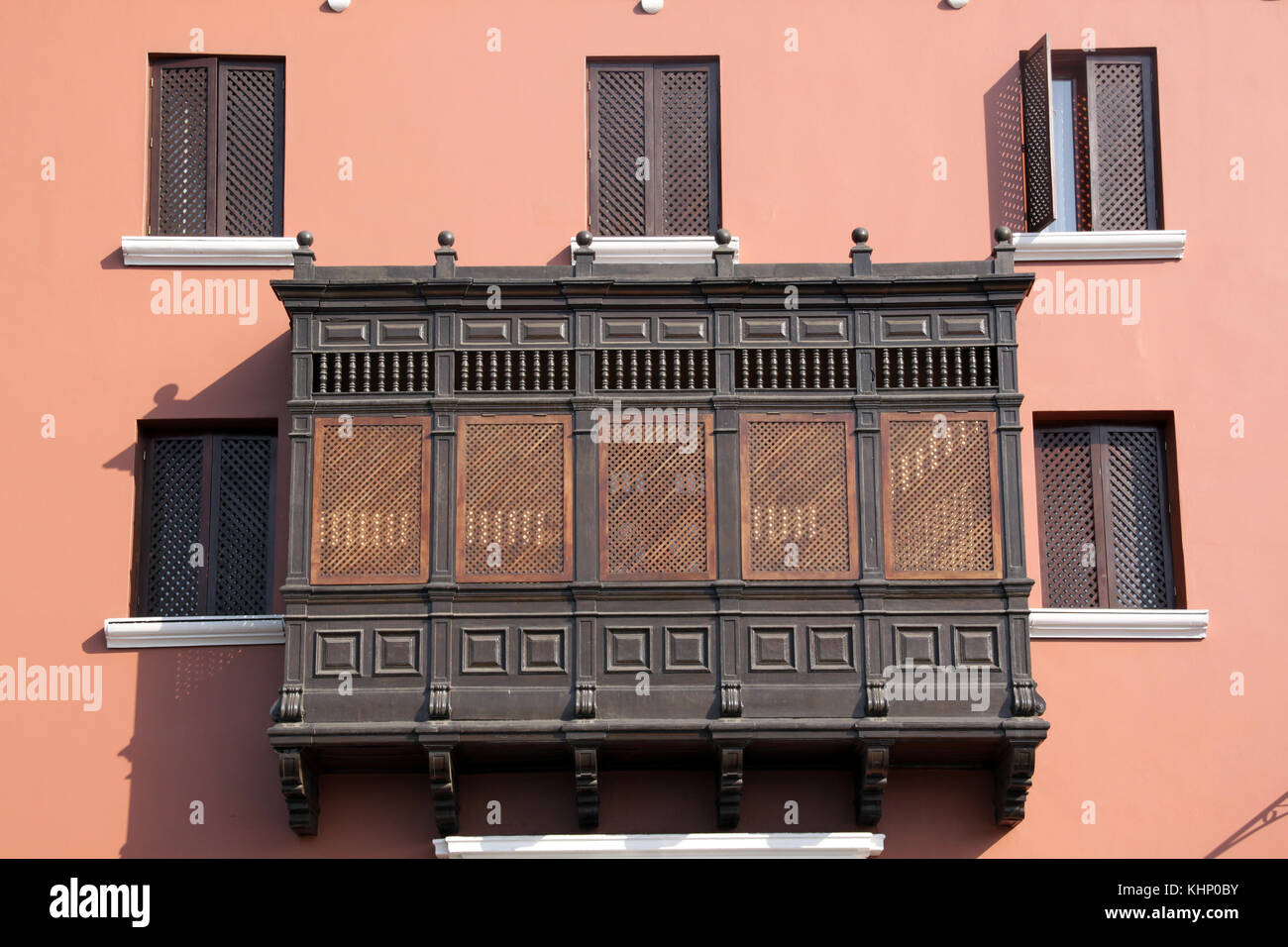 Wooden balcony, windows and pink wall of building in Trujillo, north ...