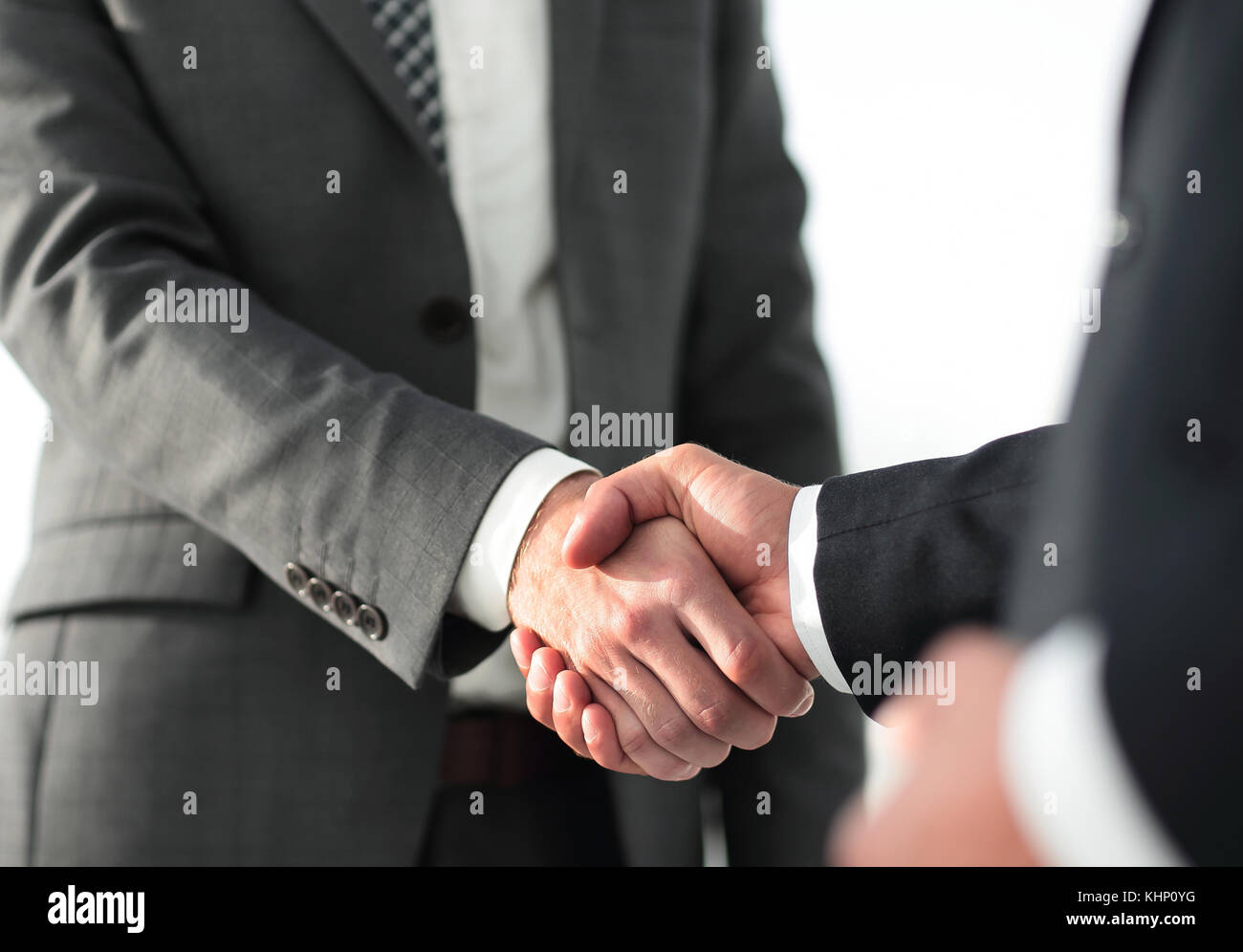 Friendly smiling businessmen handshaking. Business concept photo Stock ...