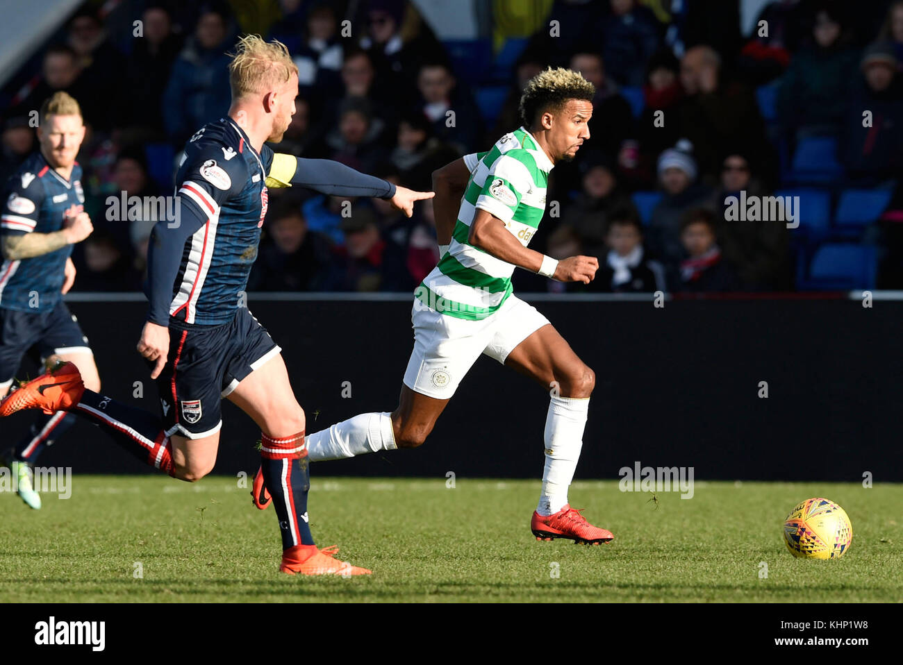 Celtic's Scott Sinclair goes on a run with Ross County's Andrew Davies ...