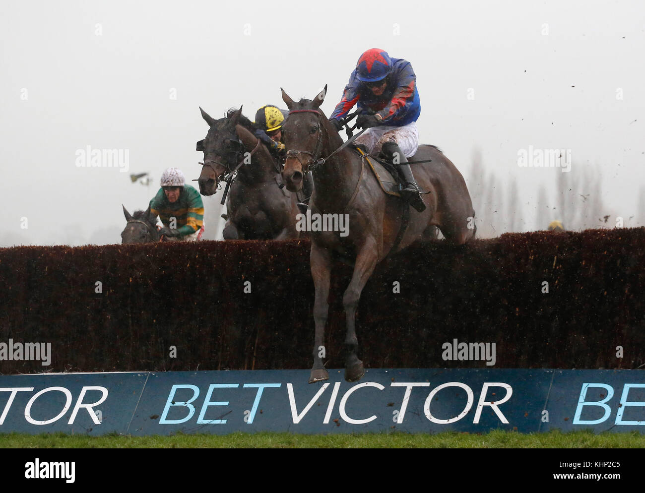 Splash Of Ginge and Tom Bellamy lead the field over the last fence ...