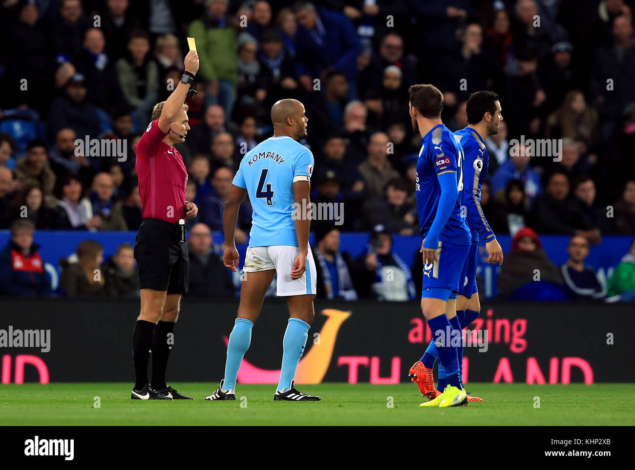 Referee Graham Scott shows Manchester City's Vincent Kompany a yellow ...