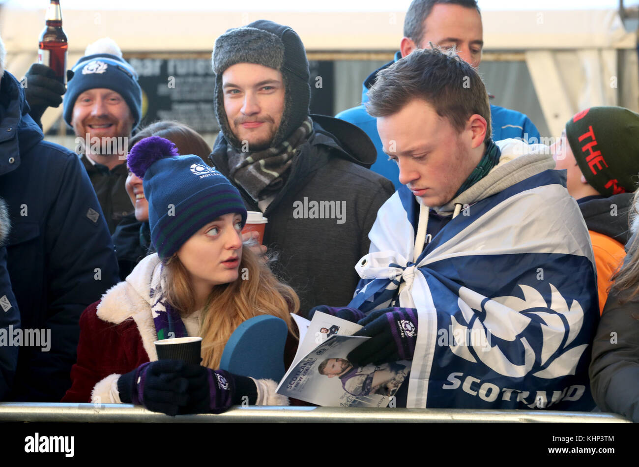 Rugby fans await the arrival of the team buses outside the stadium ...