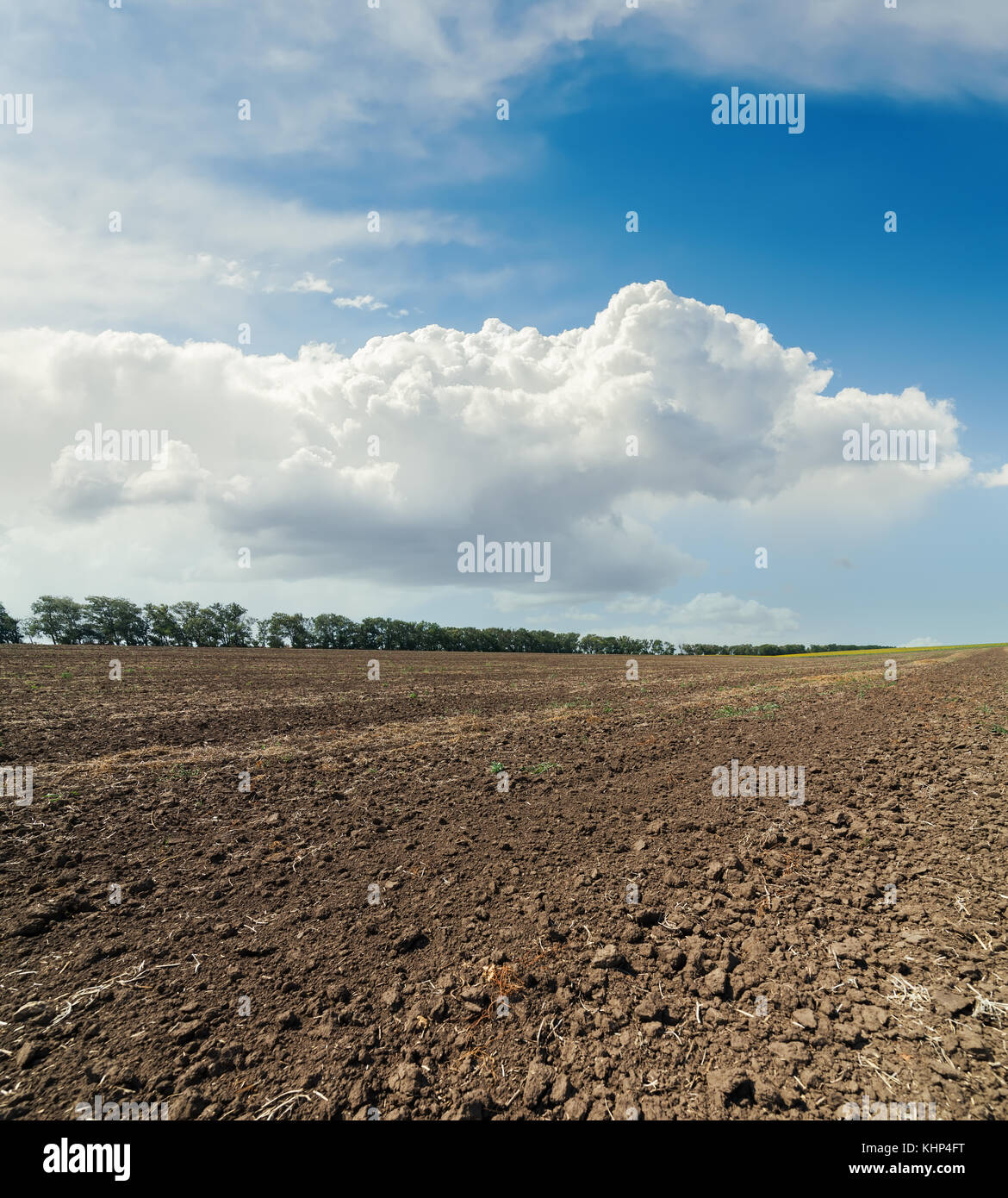 clouds in sky over plowed field Stock Photo - Alamy
